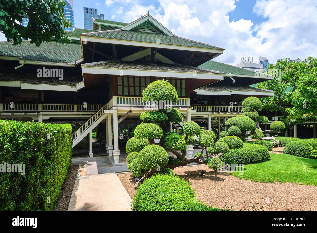 Exterior facade view with elaborate topiary landscaping. At the Nai ...