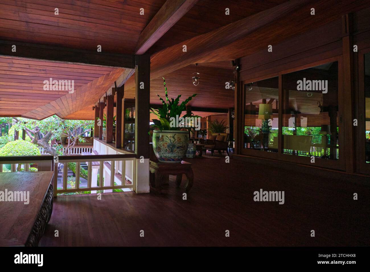 View of one of the open air verandas with dark wood paneling everywhere ...