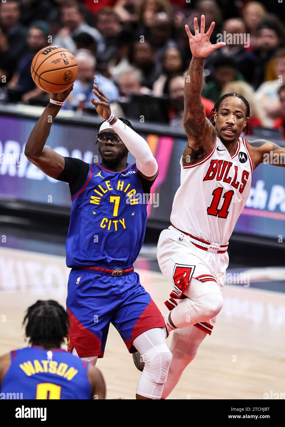 Chicago, USA. 12th Dec, 2023. Reggie Jackson (L) of Denver Nuggets passes the ball during the ...