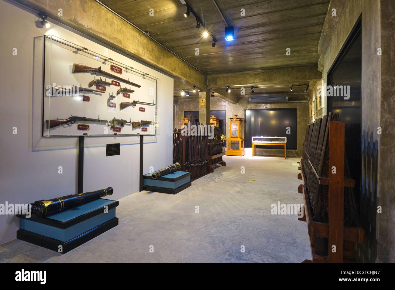 An exhibit area featuring many old rifles, guns, canons, pistols. At ...