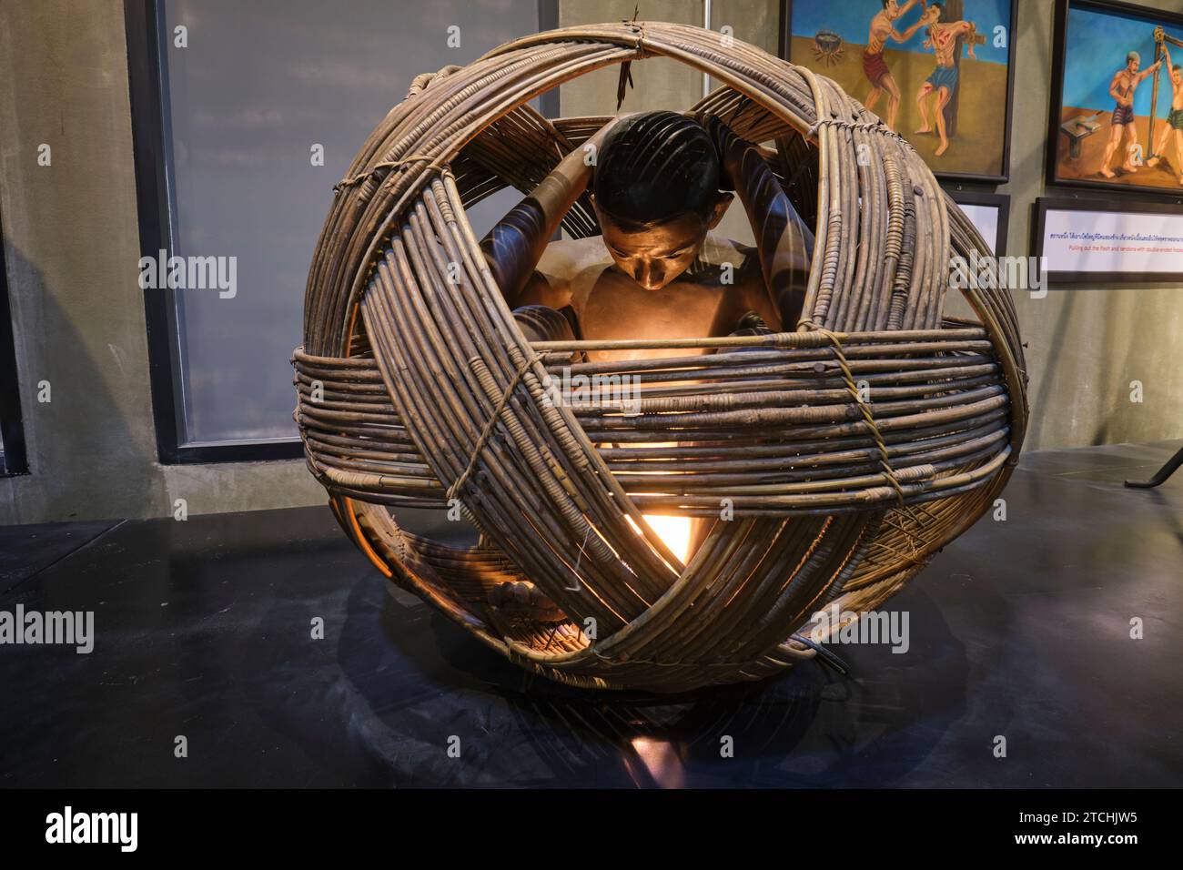 A display of a typical prisoner, locked in a rattan ball that contains ...