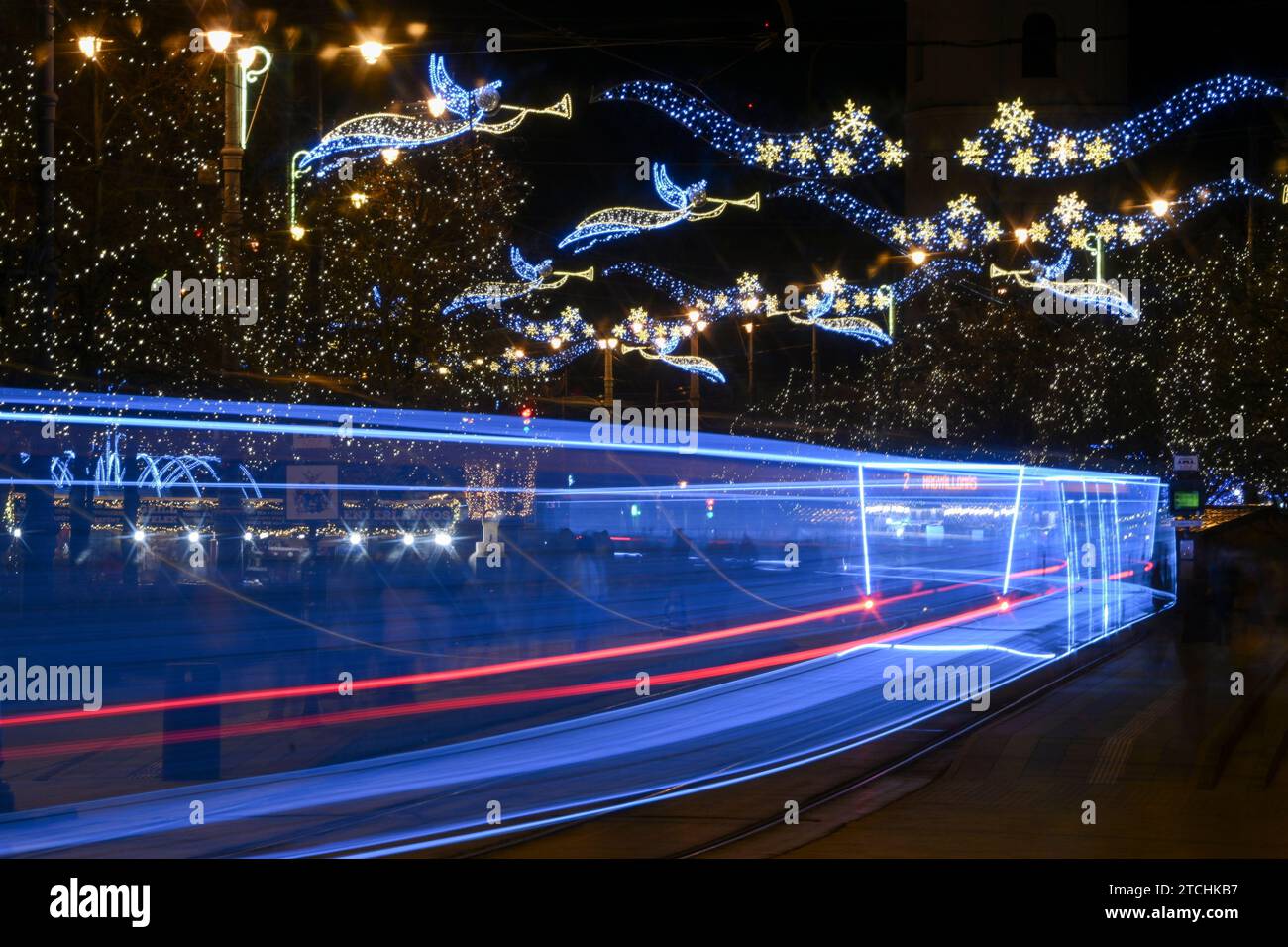 In this long exposure picture, a tram illuminated with Christmas lights ...
