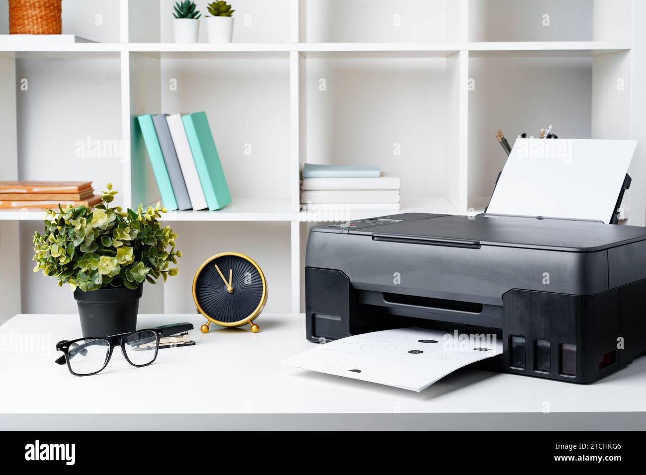 Workplace with modern printer and clock in the office Stock Photo - Alamy