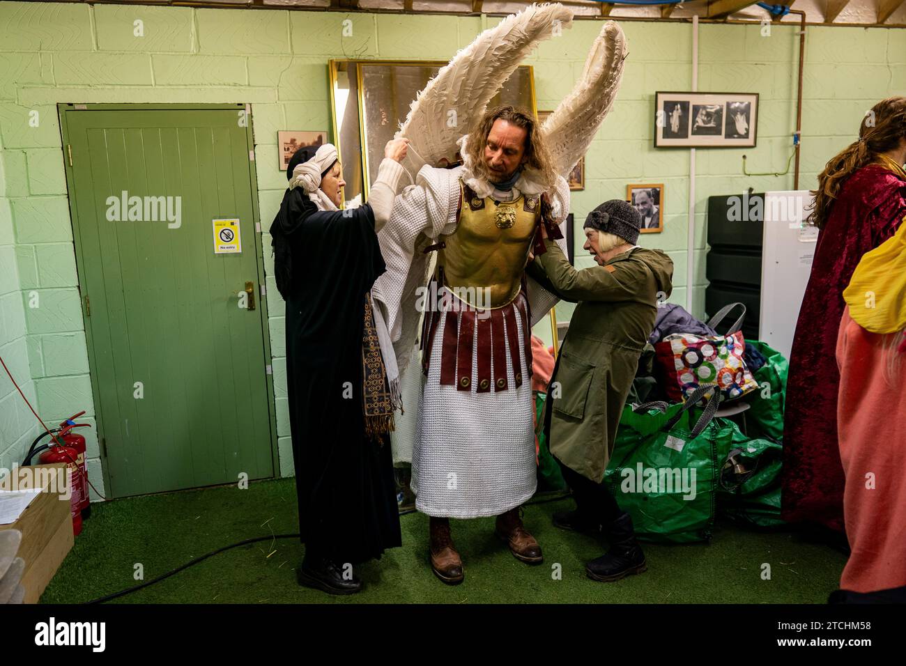 An actor playing Archangel Gabriel is helped into costume during the ...
