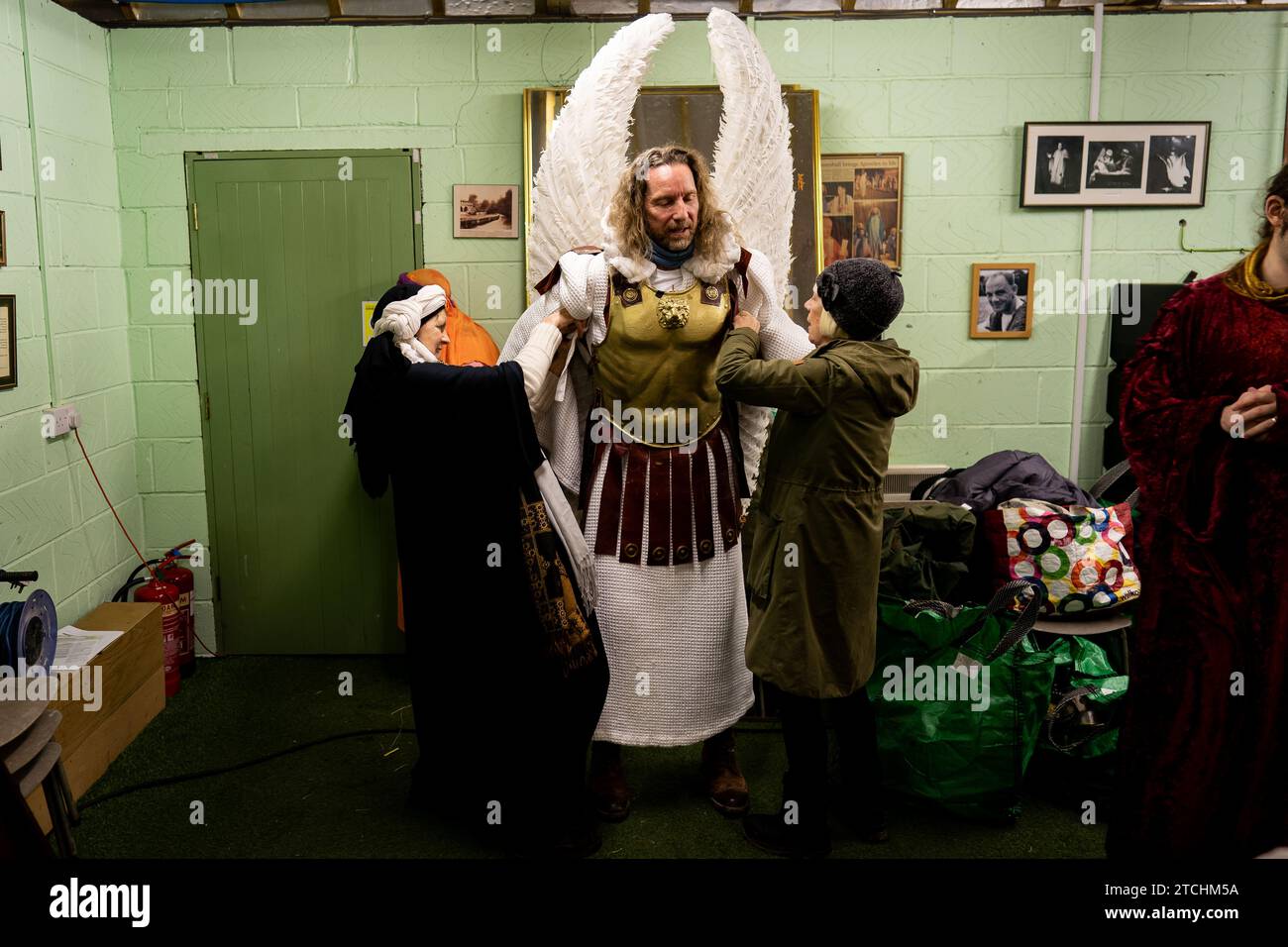 An actor playing Archangel Gabriel is helped into costume during the ...