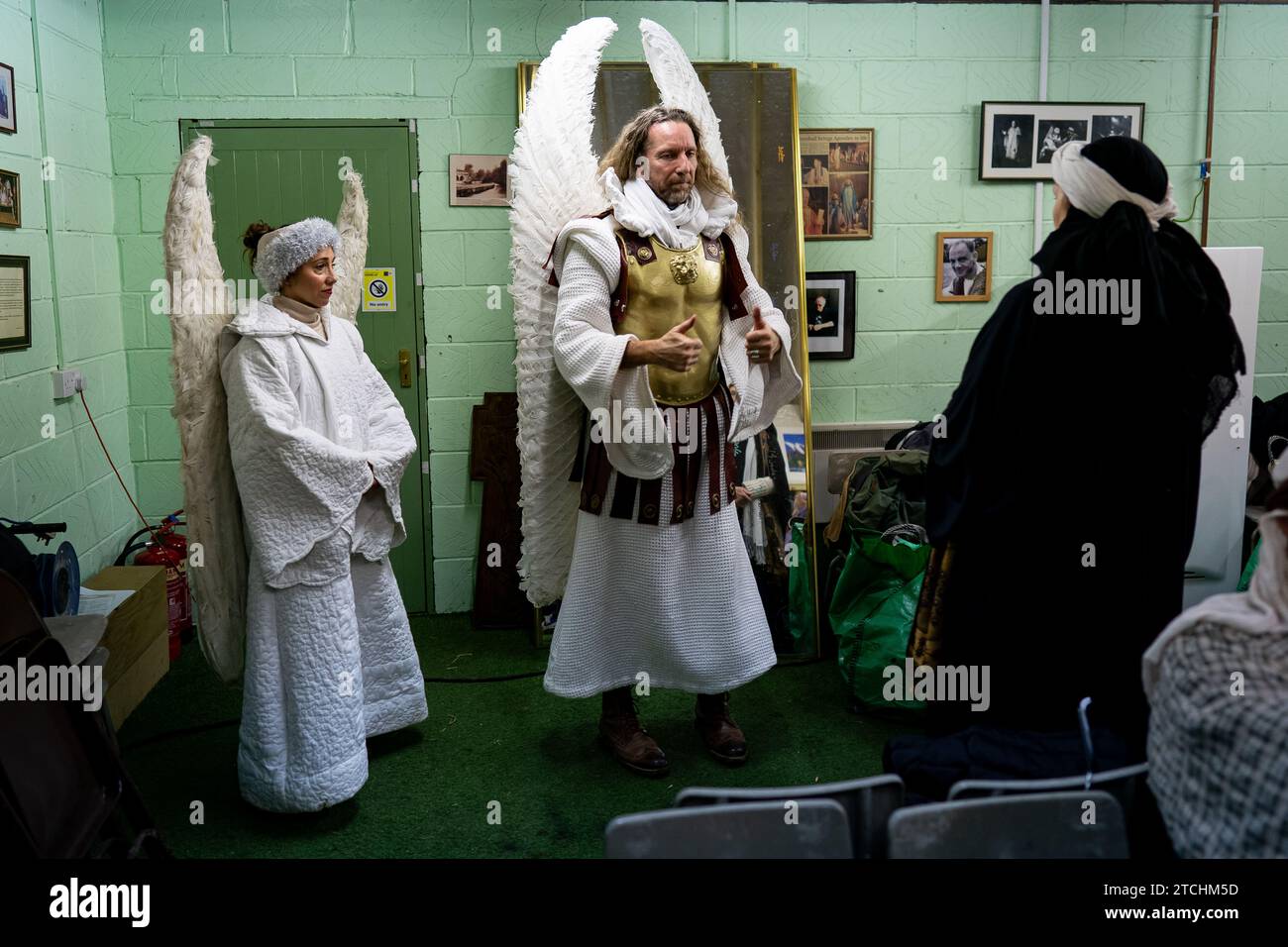 An actor playing Archangel Gabriel is helped into costume during the ...