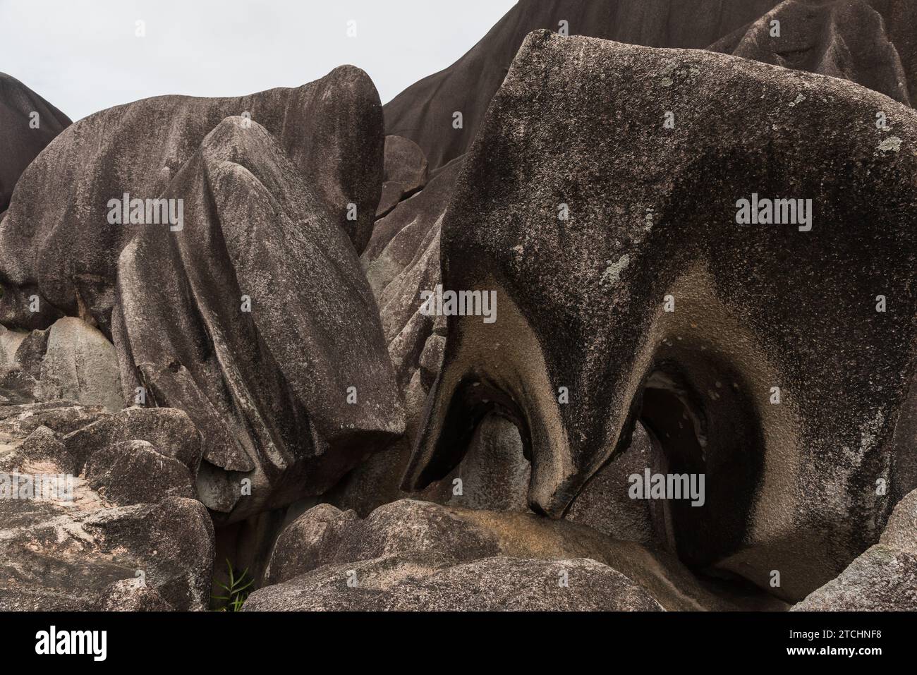 Black stones of the Giant Union Rock. Natural landmark of La Digue ...