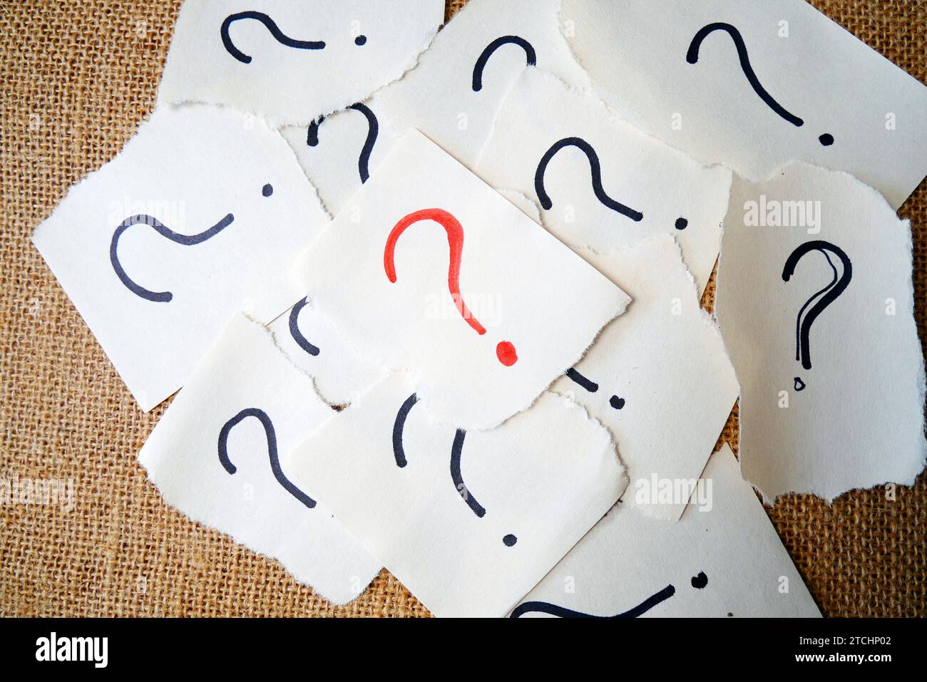 Torn paper showing question mark symbol on yellow background with copy ...