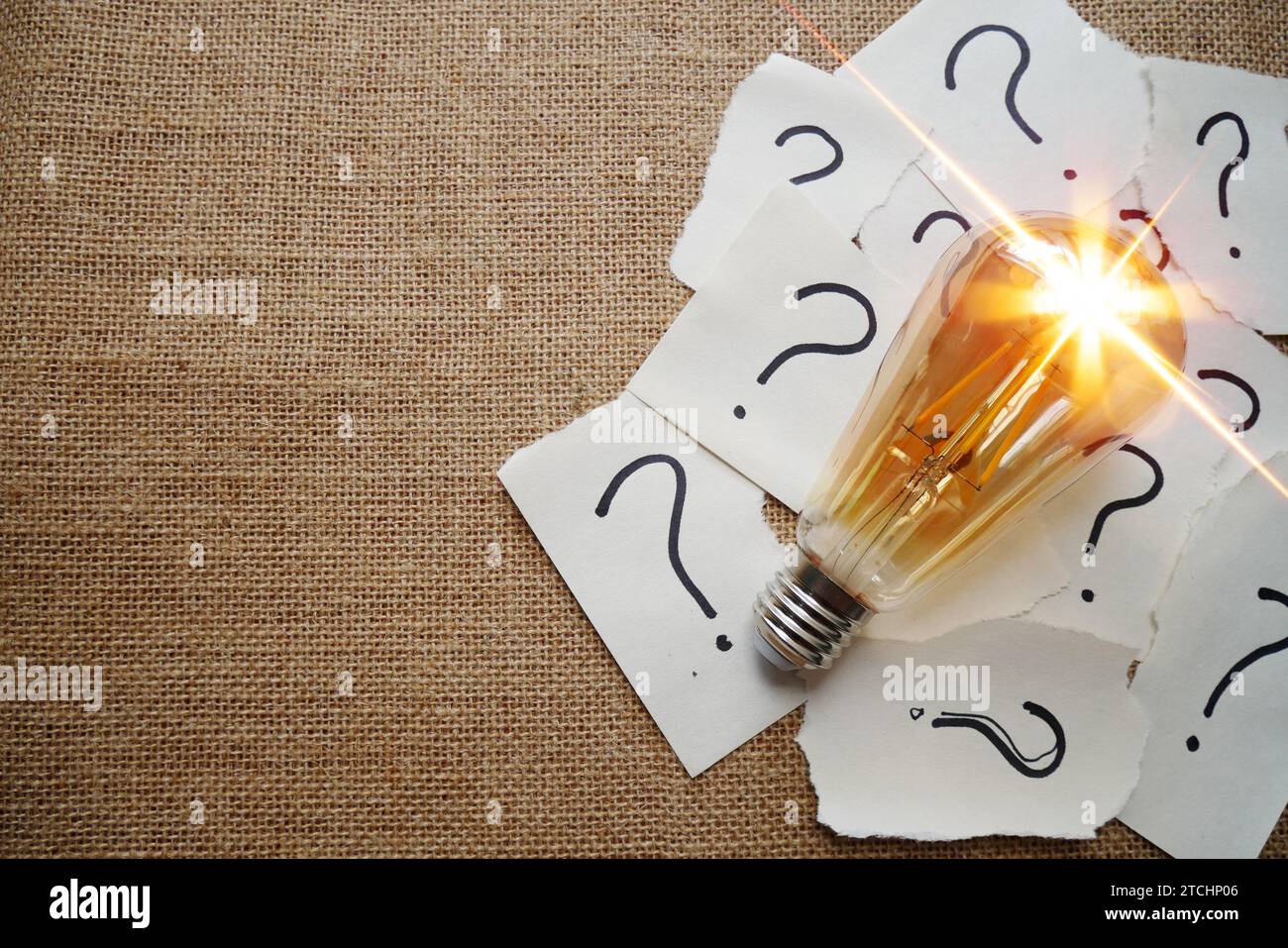 Torn paper showing question mark symbol on yellow background with copy ...