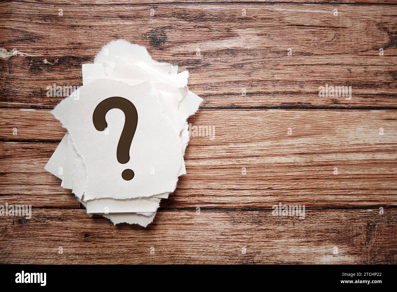 Torn paper showing question mark symbol on yellow background with copy ...