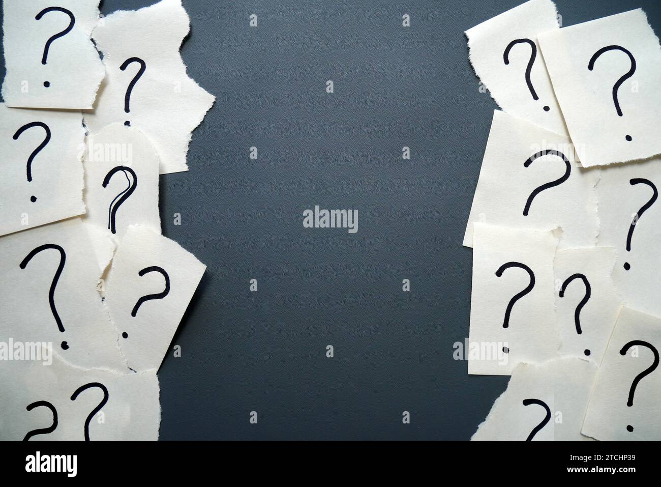 Torn paper showing question mark symbol on yellow background with copy ...