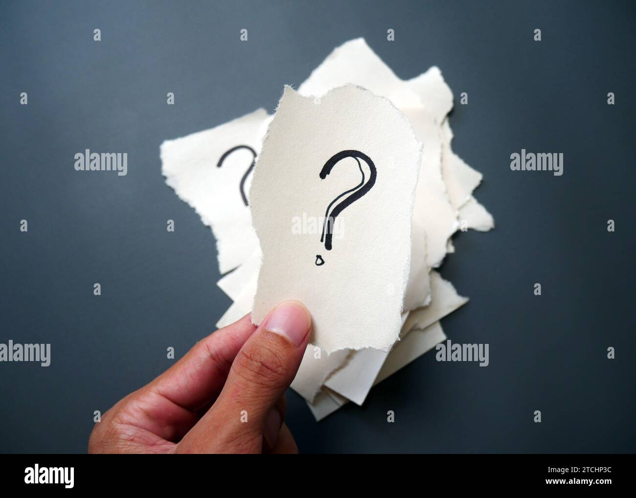 Torn paper showing question mark symbol on yellow background with copy ...