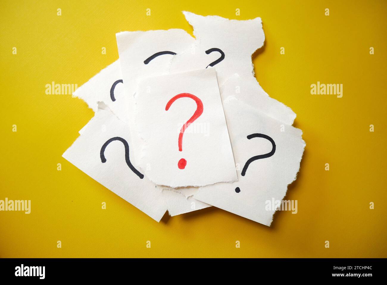 Torn paper showing question mark symbol on yellow background with copy ...