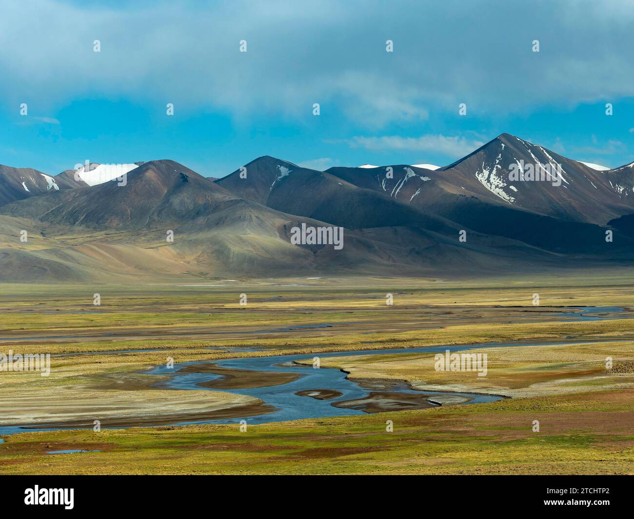 Mountain landscape and wide plain with river, highlands of Tibet, China ...