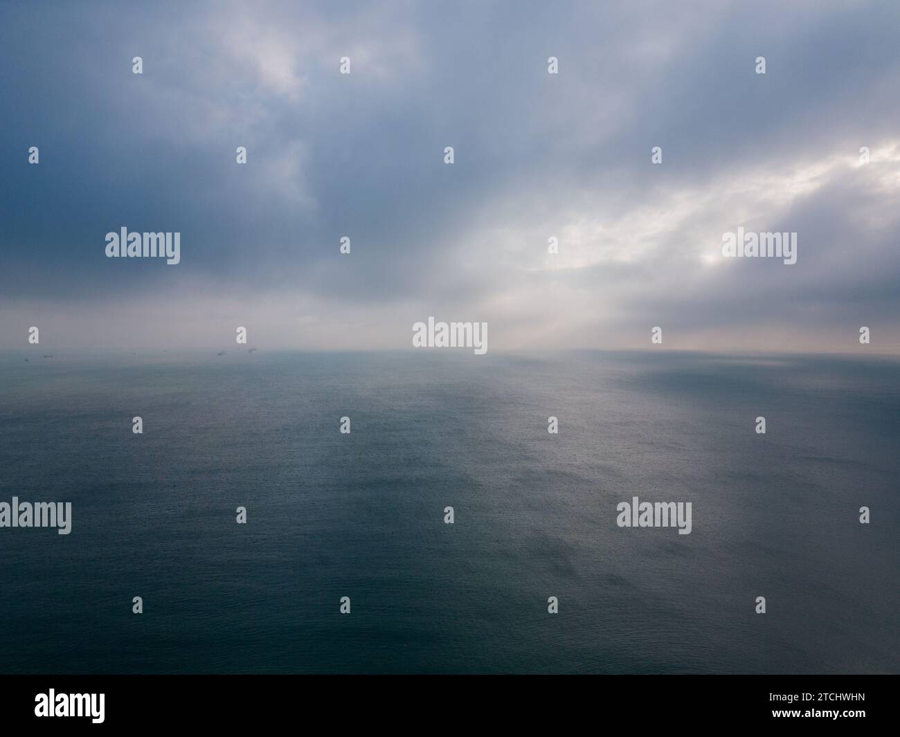 Aerial view of a dark sea, horizon, and dramatic sky before a storm ...