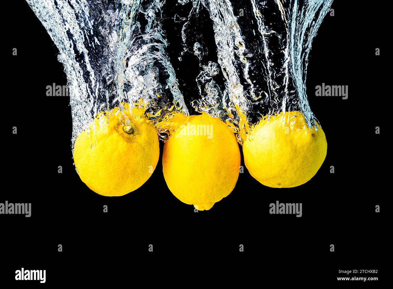 Lemons splash into water and sinking on black background. Tasty and healthy food Stock Photo - Alamy