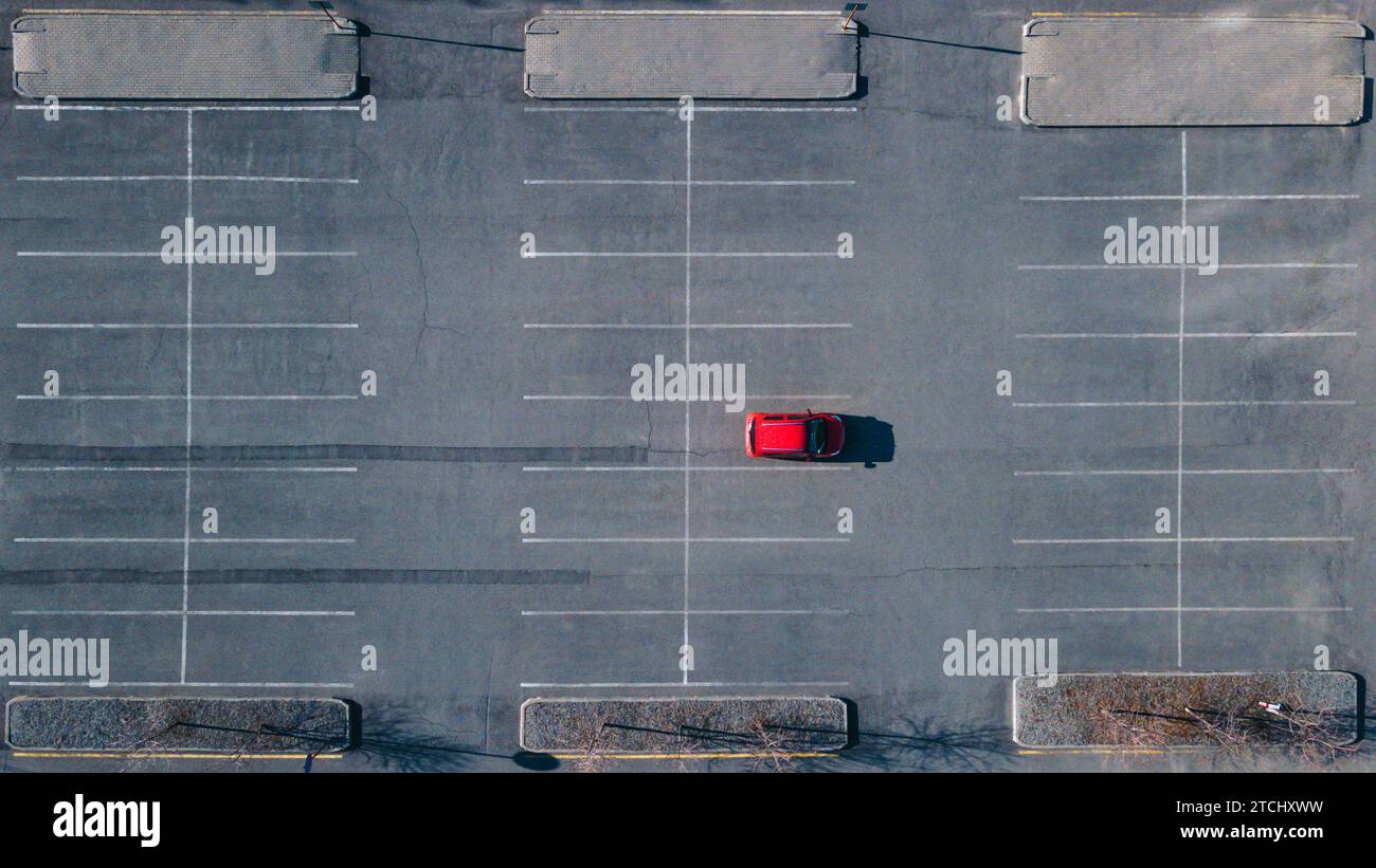 A red car is standing alone in the parking lot. View from a drone Stock ...
