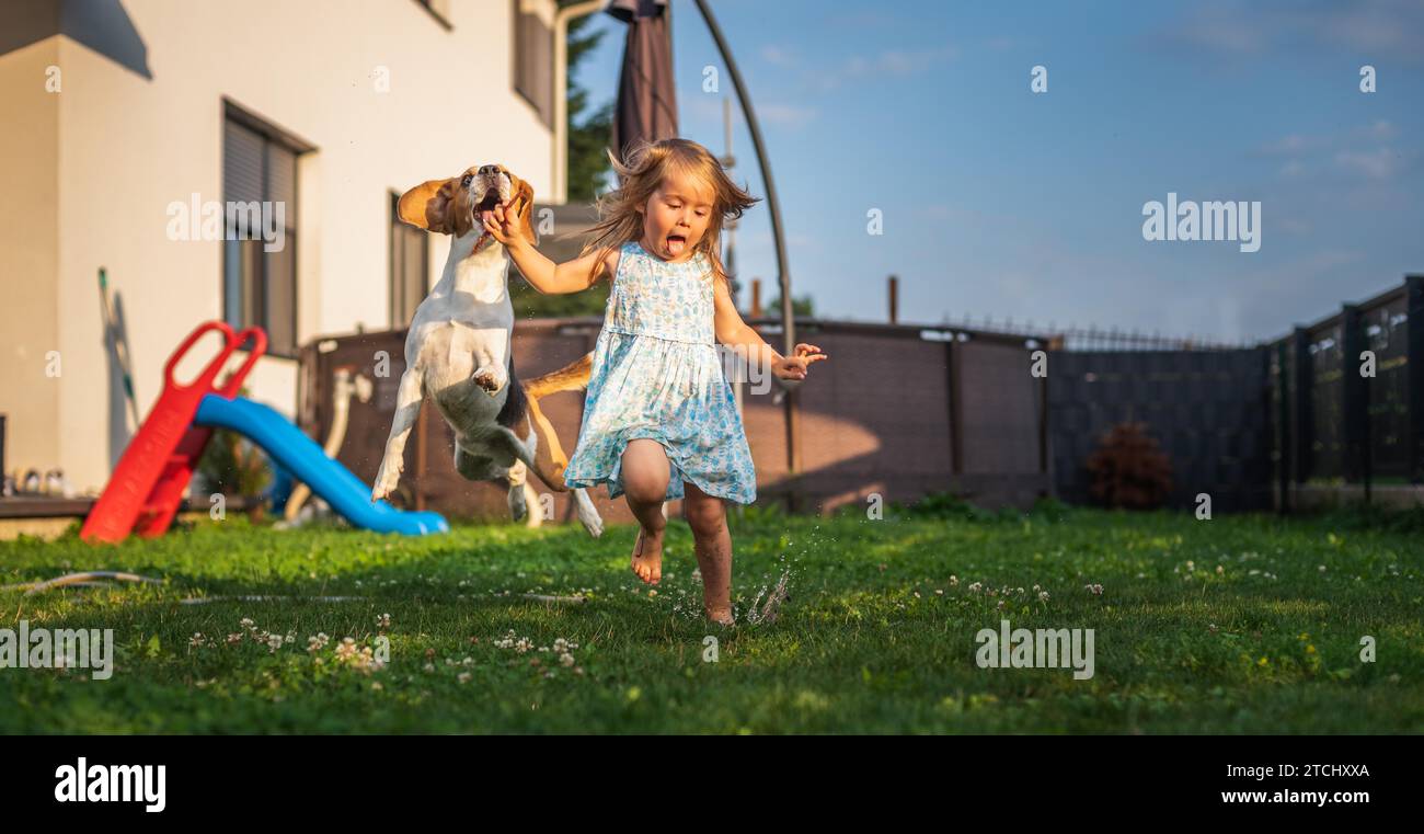Child chasing dog hi-res stock photography and images - Alamy