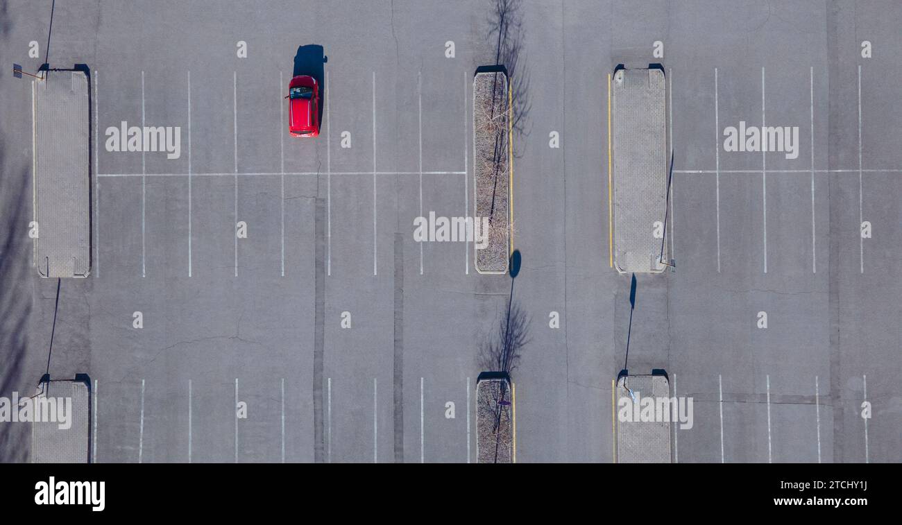 A red car is parked in an empty parking lot. View from a drone Stock ...