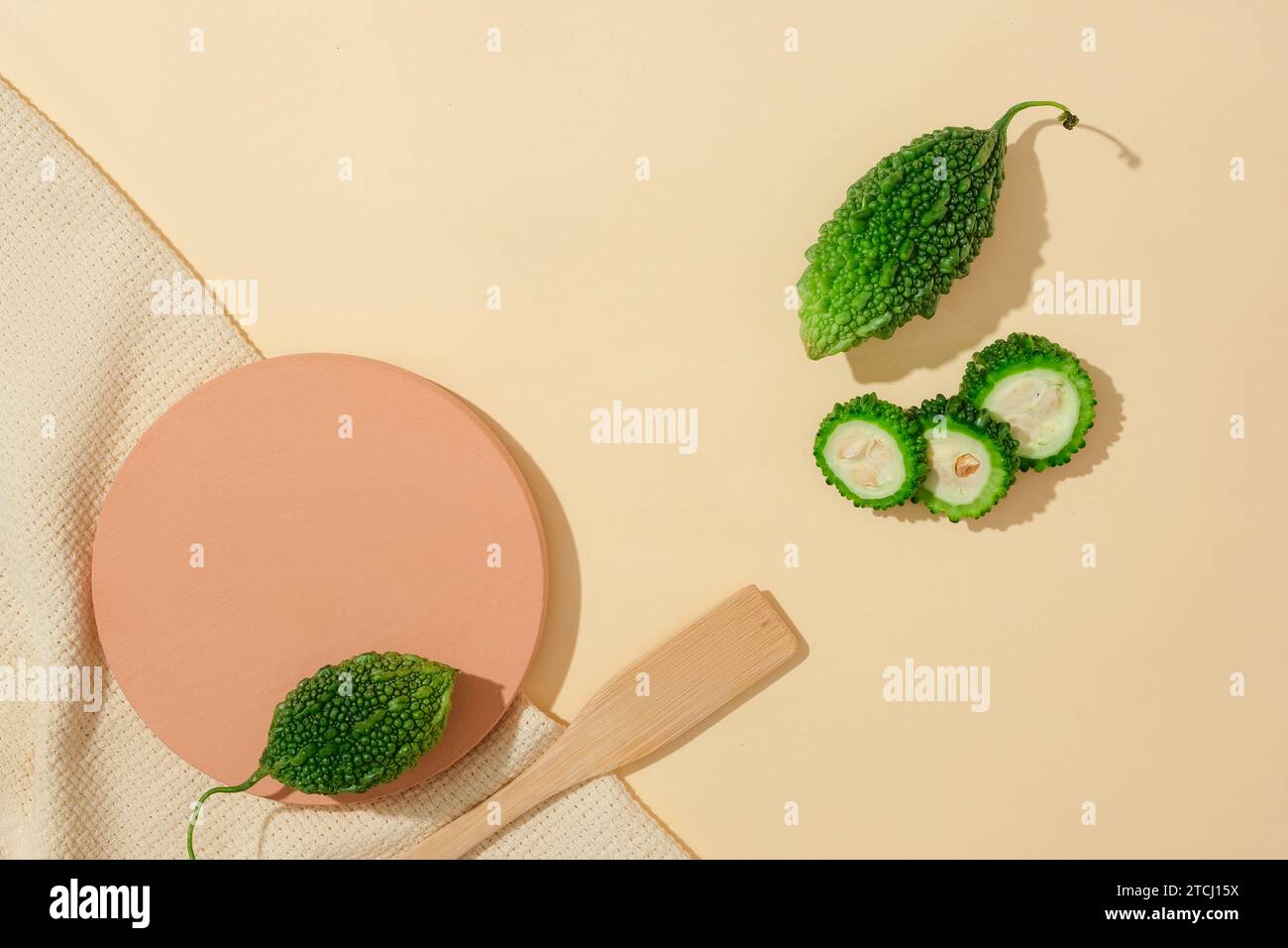 Top view of a round platform is displayed with fresh bitter melon on a ...