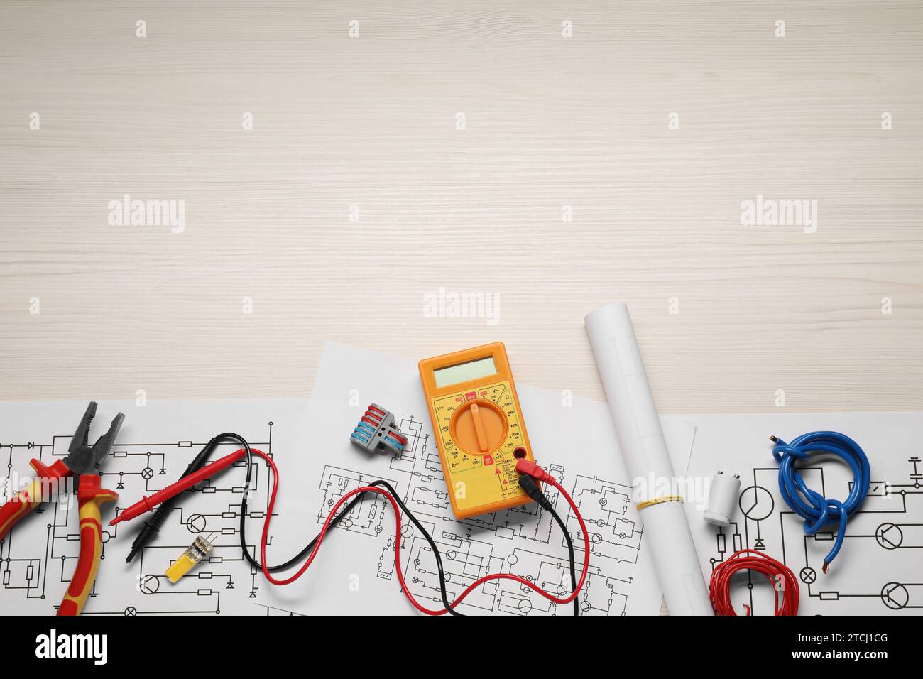 Flat lay composition with wiring diagrams and digital multimeter on ...