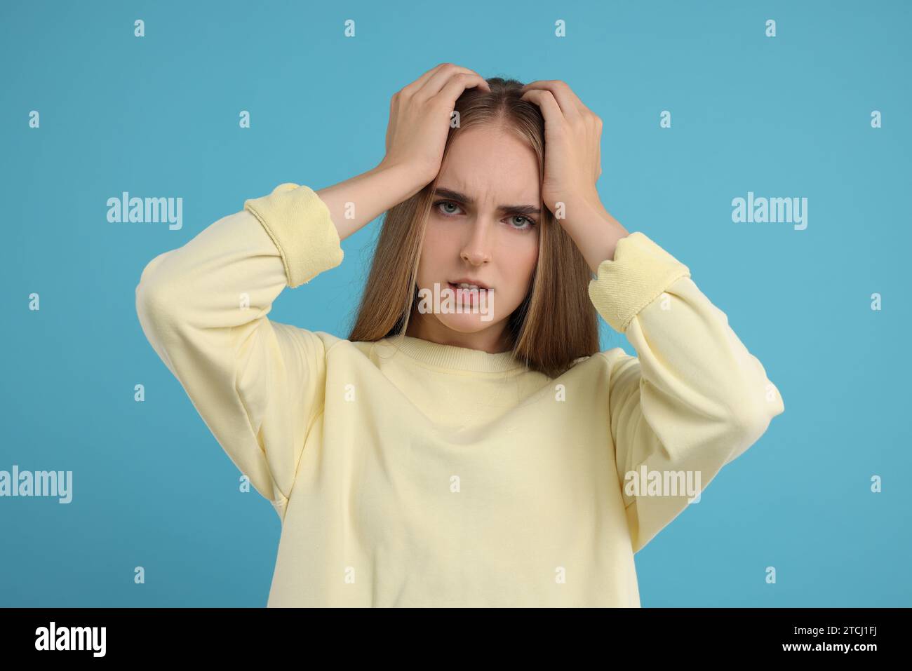 Portrait of resentful woman on light blue background Stock Photo - Alamy