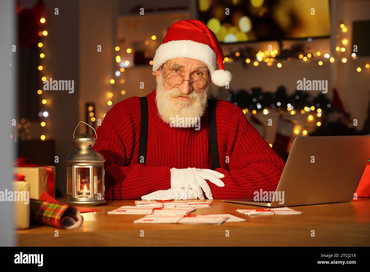 Santa Claus at his workplace. Letters and laptop on table in room ...