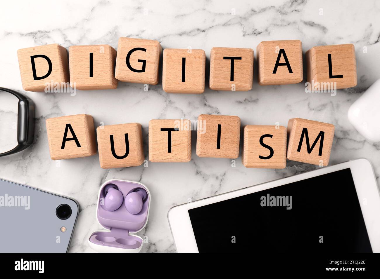 Phrase Digital Autism made of wooden cubes and devices on white marble ...