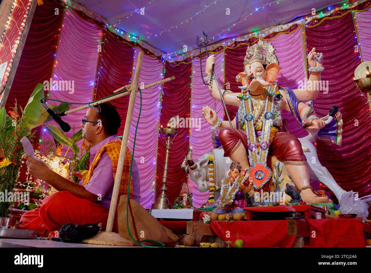 During festival Ganesh Chaturthi in Mumbai, India, a Hindu priest sits ...