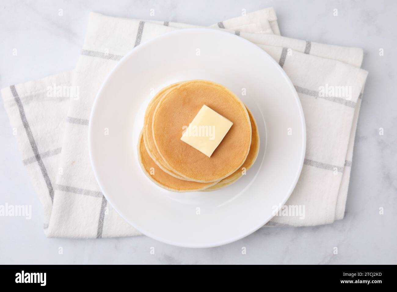Delicious pancakes with butter on marble table, top view Stock Photo ...