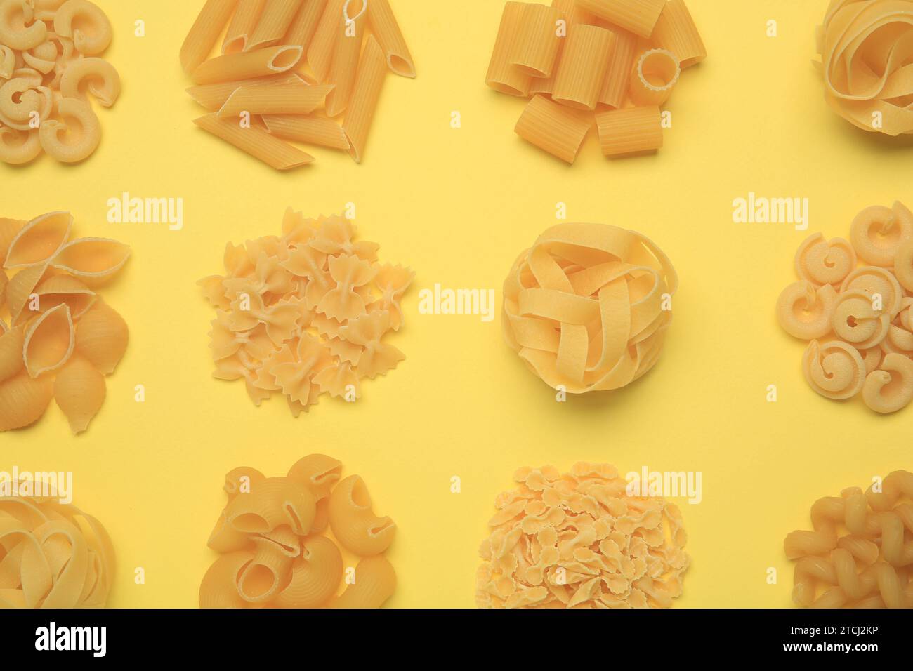Different types of pasta on yellow background, flat lay Stock Photo - Alamy
