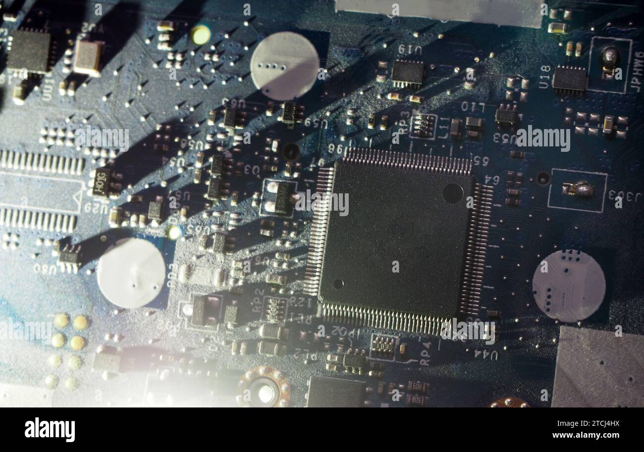 Hi-tech background with illuminated electronic circuit board texture. Microhip or CPU on the ...
