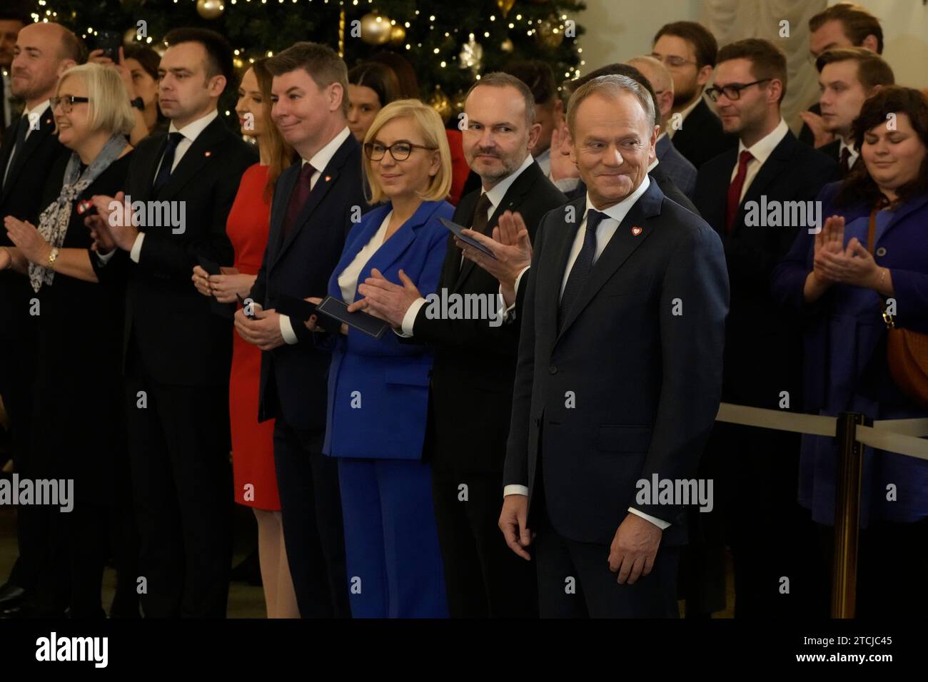 Poland's new Prime Minister Donald Tusk, right, stands next to ministers during the swearing-in ...