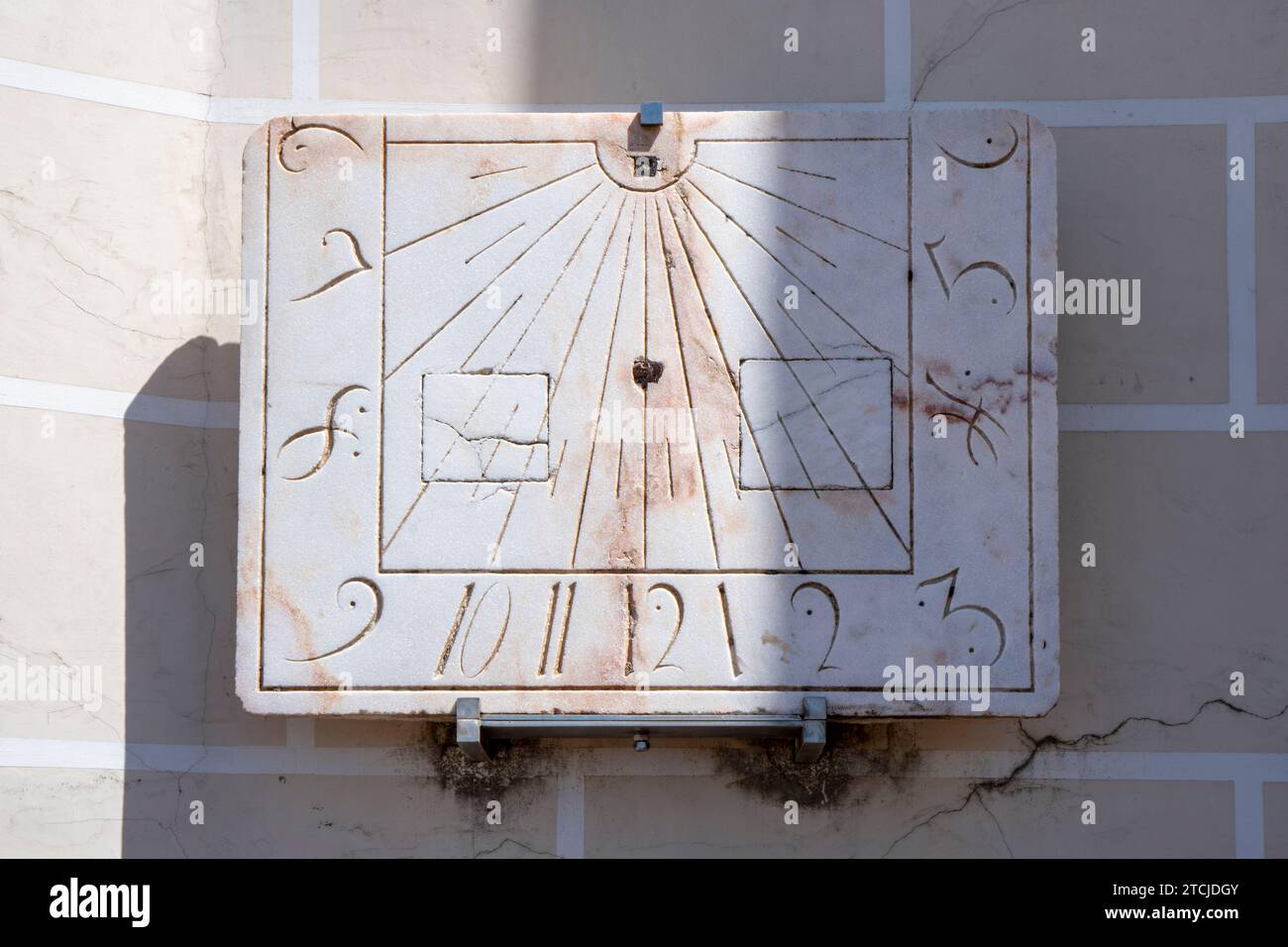 Medieval sundial in marble stone with sculpted and engraved numbers ...