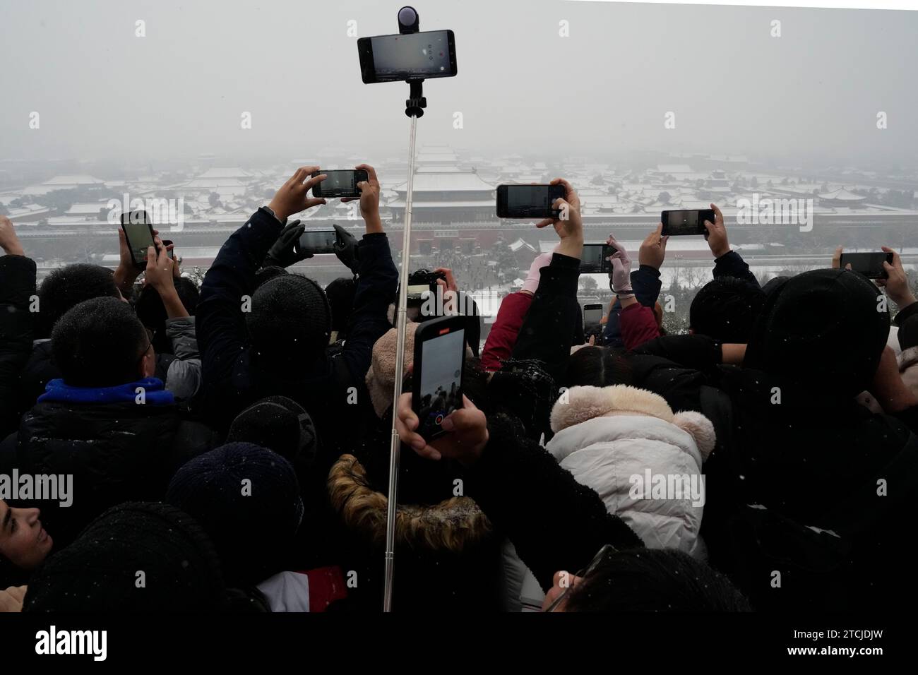 Visitors struggle for better positions to see good views of the snow ...