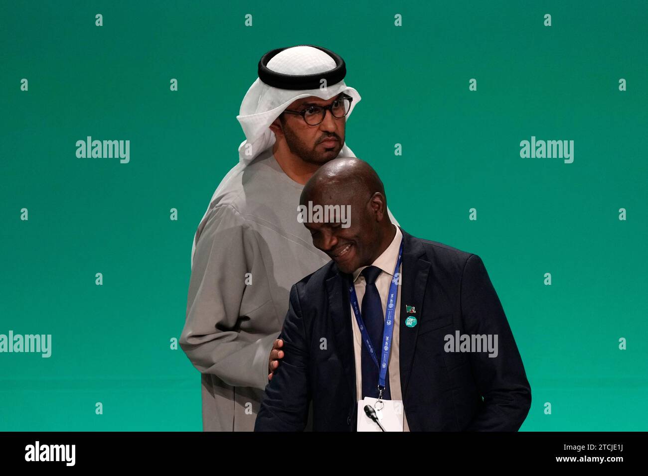 COP28 President Sultan al-Jaber walks past Chair of the African Group ...