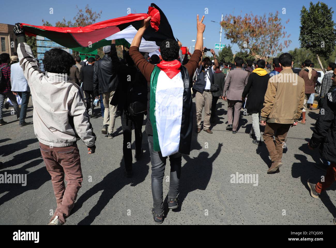 SANAA, Sanaa, Yemen. 13th Dec, 2023. Yemenis wave flags and chant ...