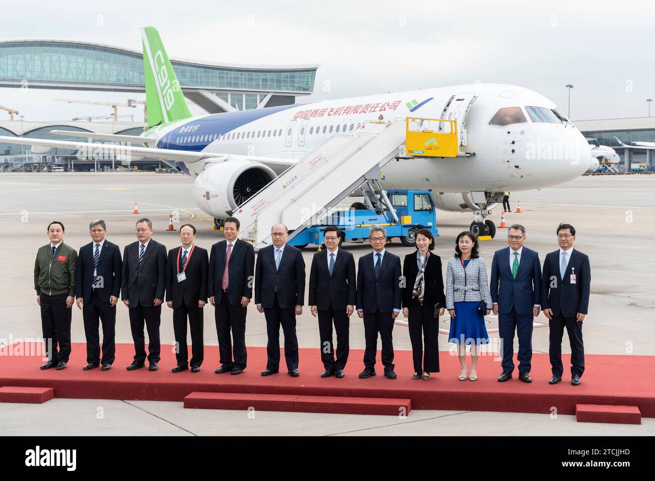 John Lee, center, Hong Kong Chief Executive, poses for photographs with guests during the ...