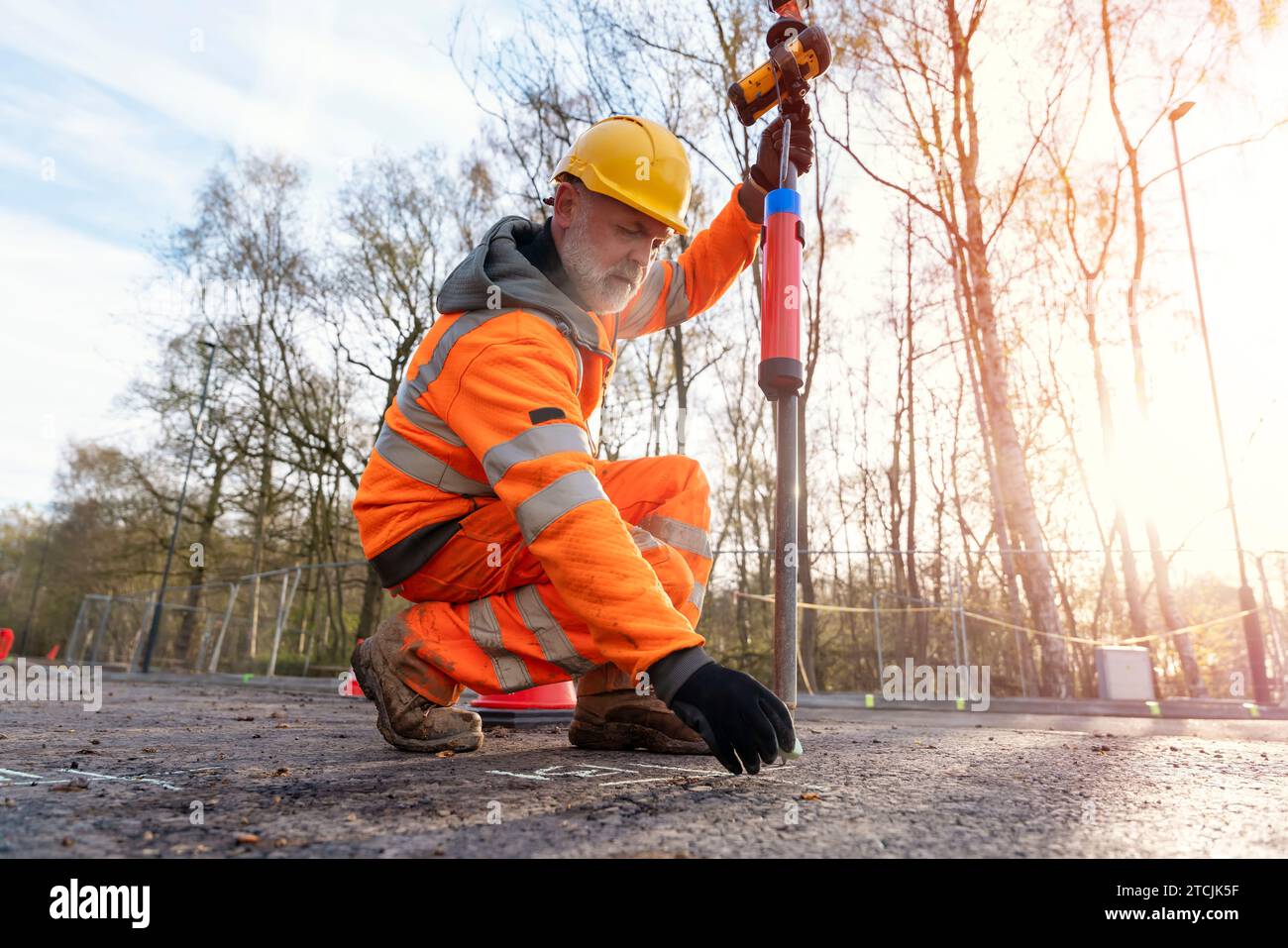 Surveyor operating his touch screen controller instrument during ...
