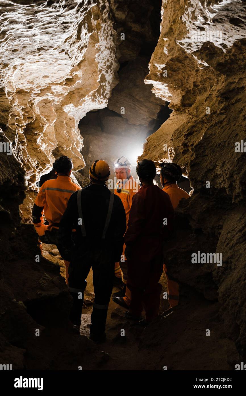 Five men, strong physique, explore the cave. Men dressed in special ...