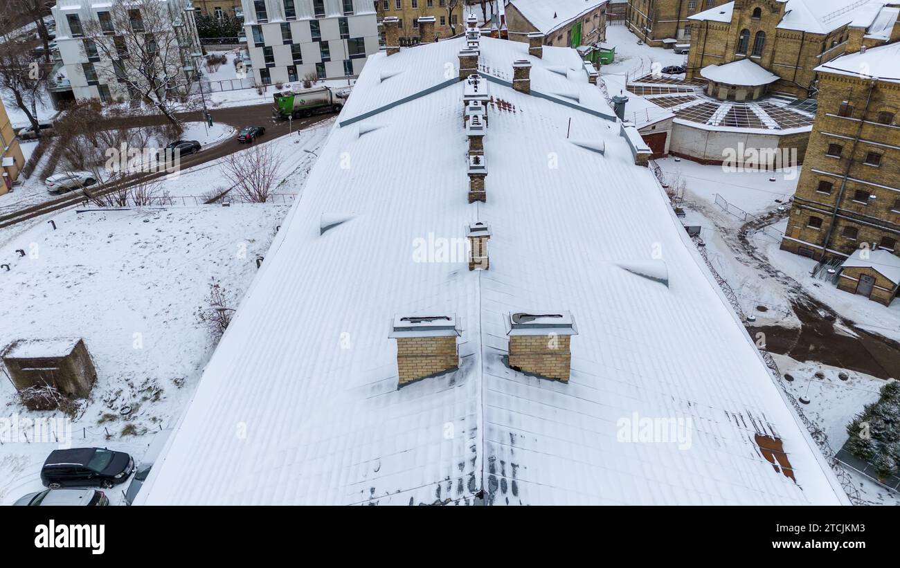 Drone photography of old prison rooftop with chimneys during winter day ...