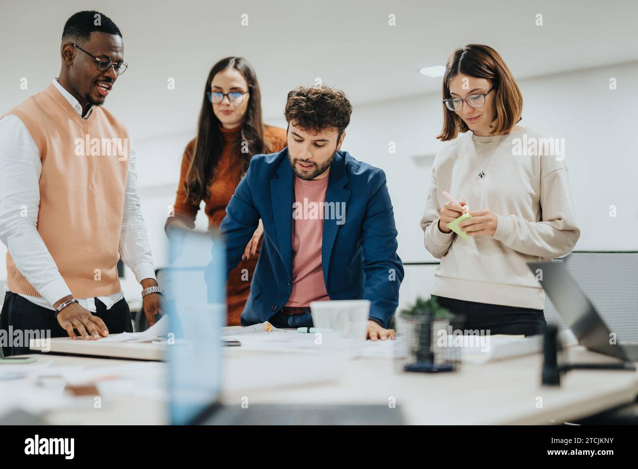 Cross generational team analyzing reports, late night collaboration for ...