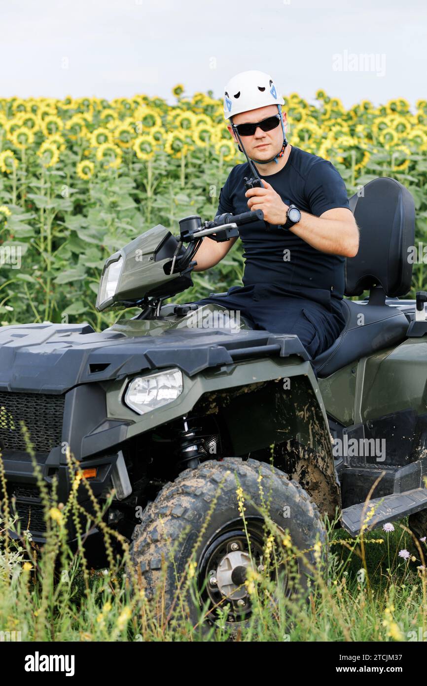 The rescuer, a beautiful athletic physique, rides an ATV in the middle ...