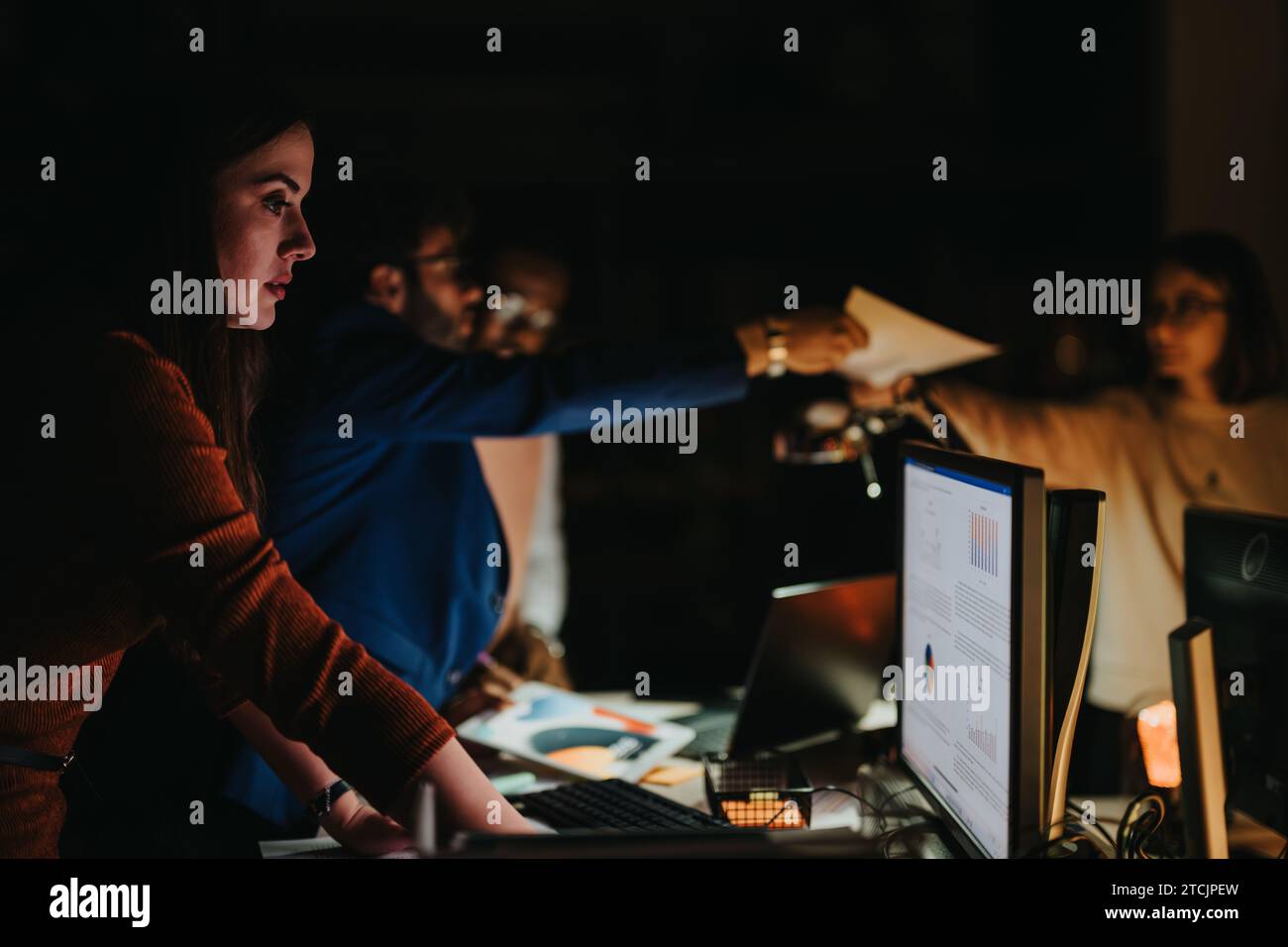 Diverse business team working late hours, collaborating and analyzing ...