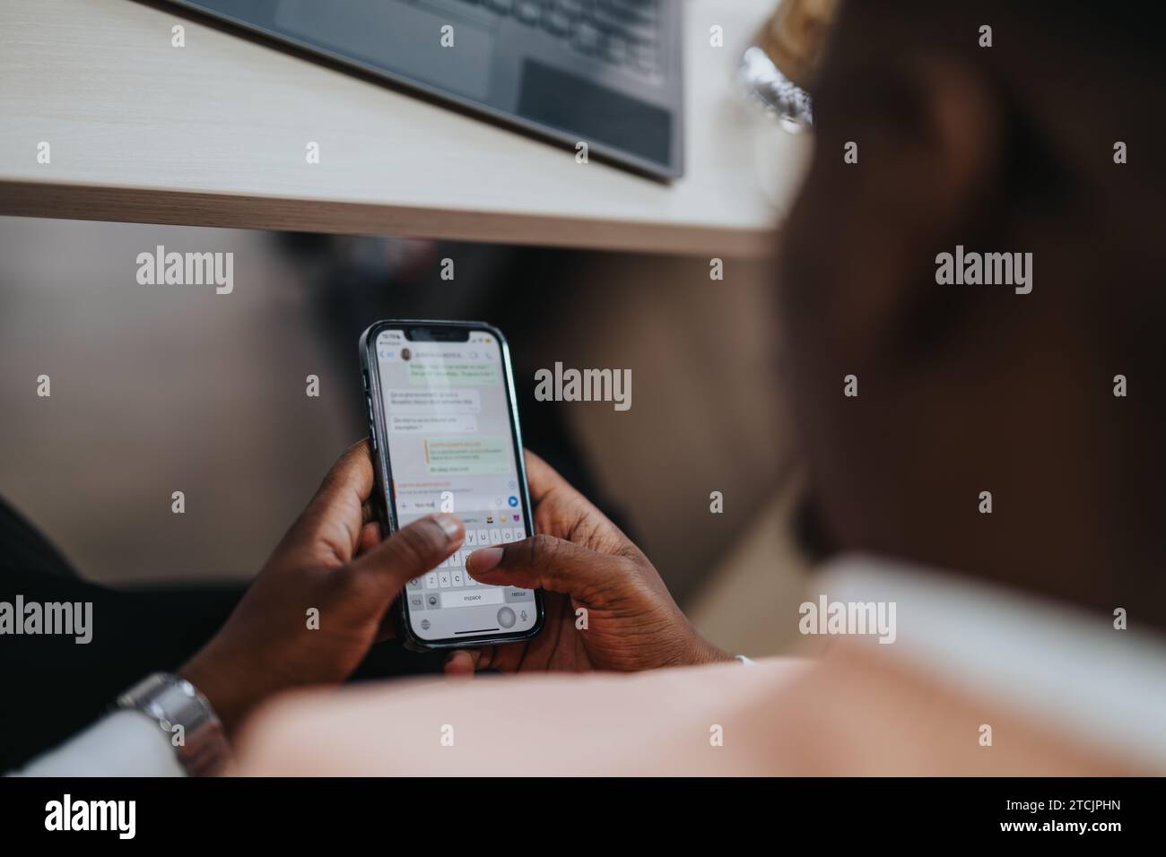 Male employee chatting on social media with friends while taking a ...