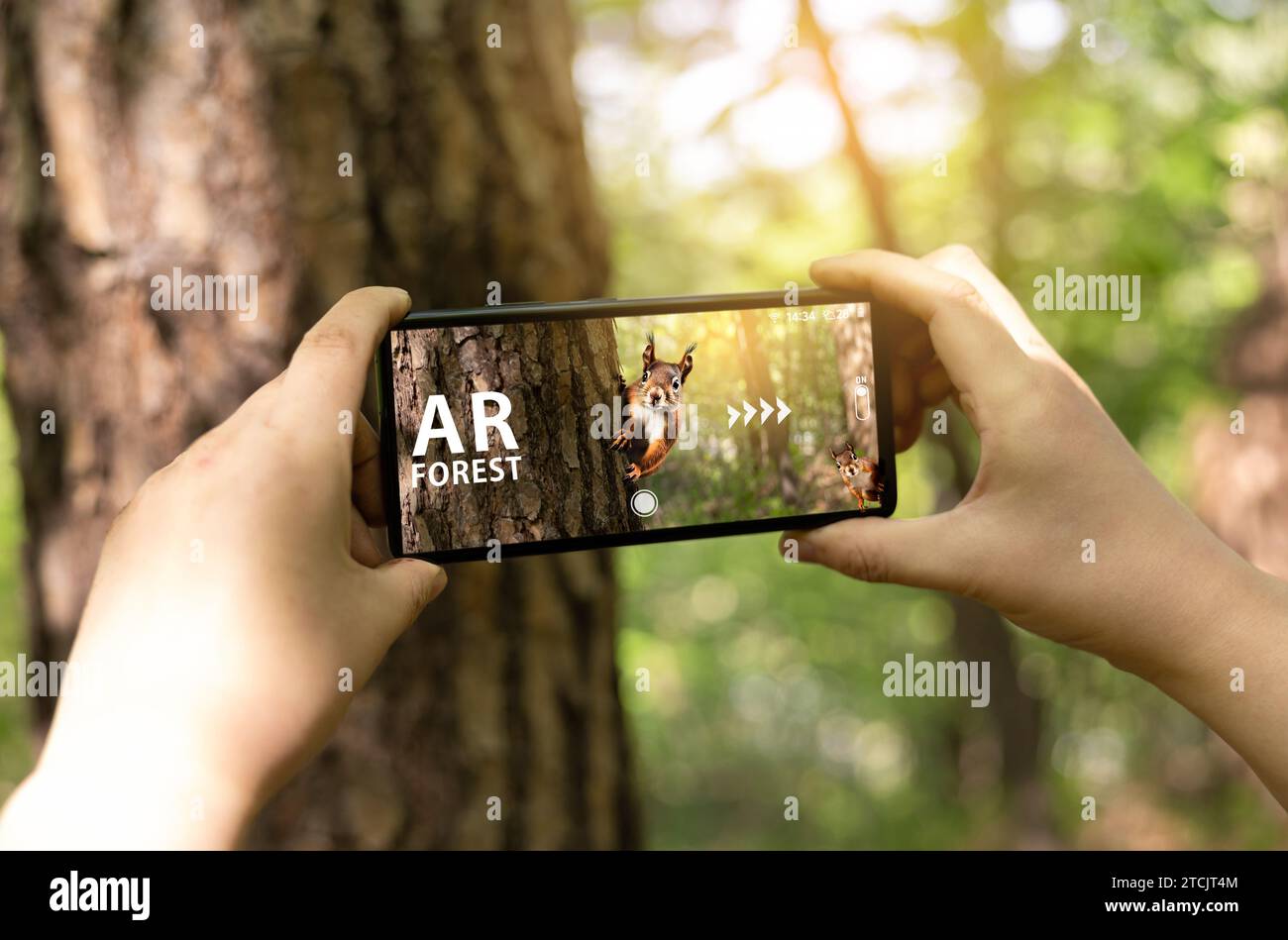 Hand of a woman experiencing an augmented reality (AR) application ...