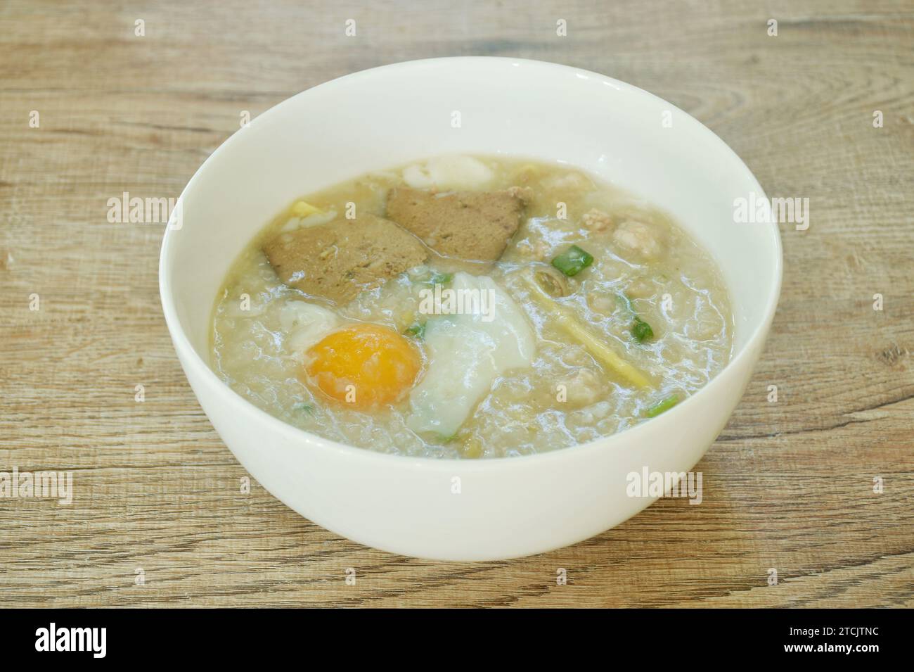 rice porridge mashed pork with chop spring onion and parsley topping ...