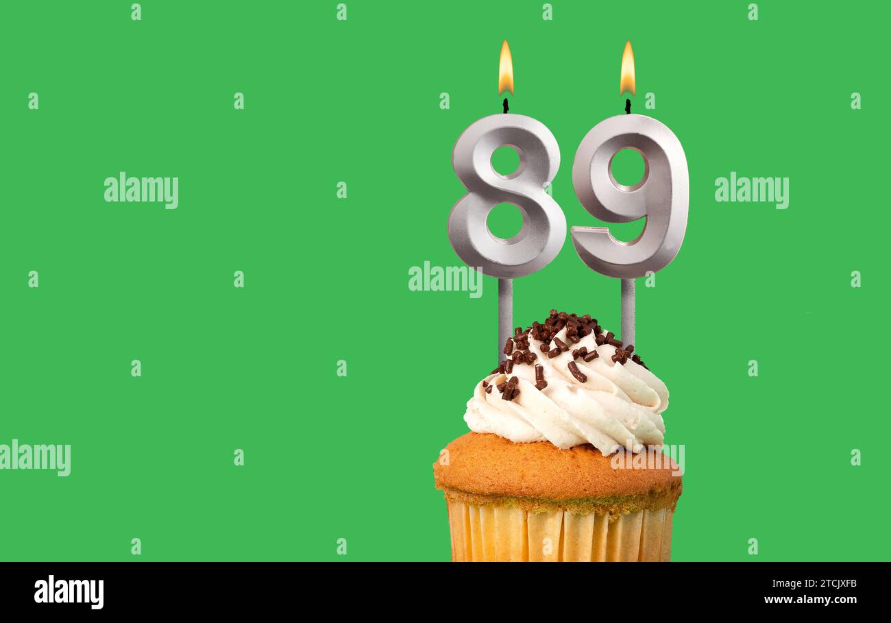 Birthday with number 89 candle and cupcake - Anniversary card on green ...