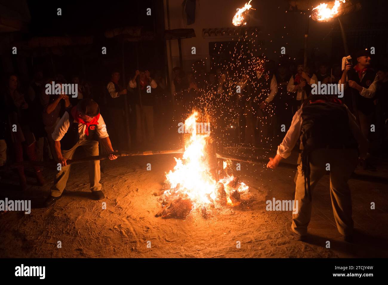 Villagers are seen lighting a torch on a bonfire outside a chapel as ...