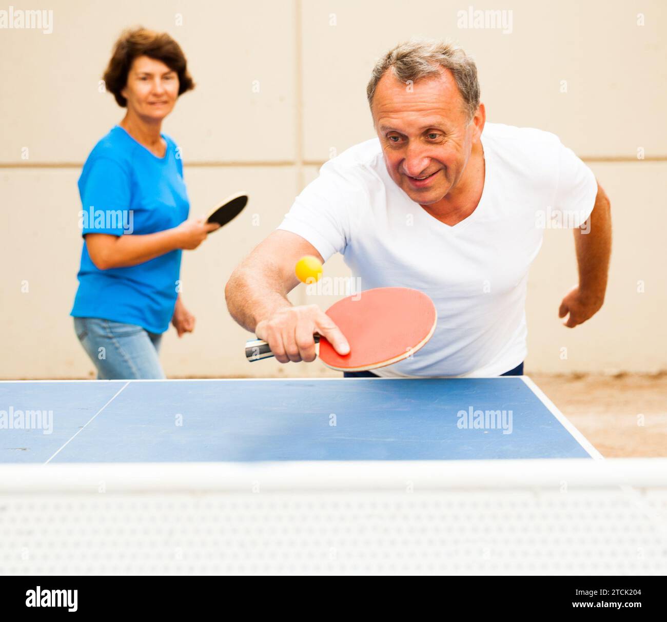 Old couple playing table tennis hi-res stock photography and images - Alamy